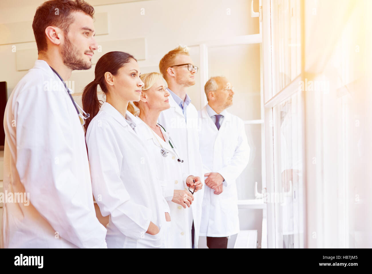 Group of doctors looking through the window at healthcare clinic Stock ...