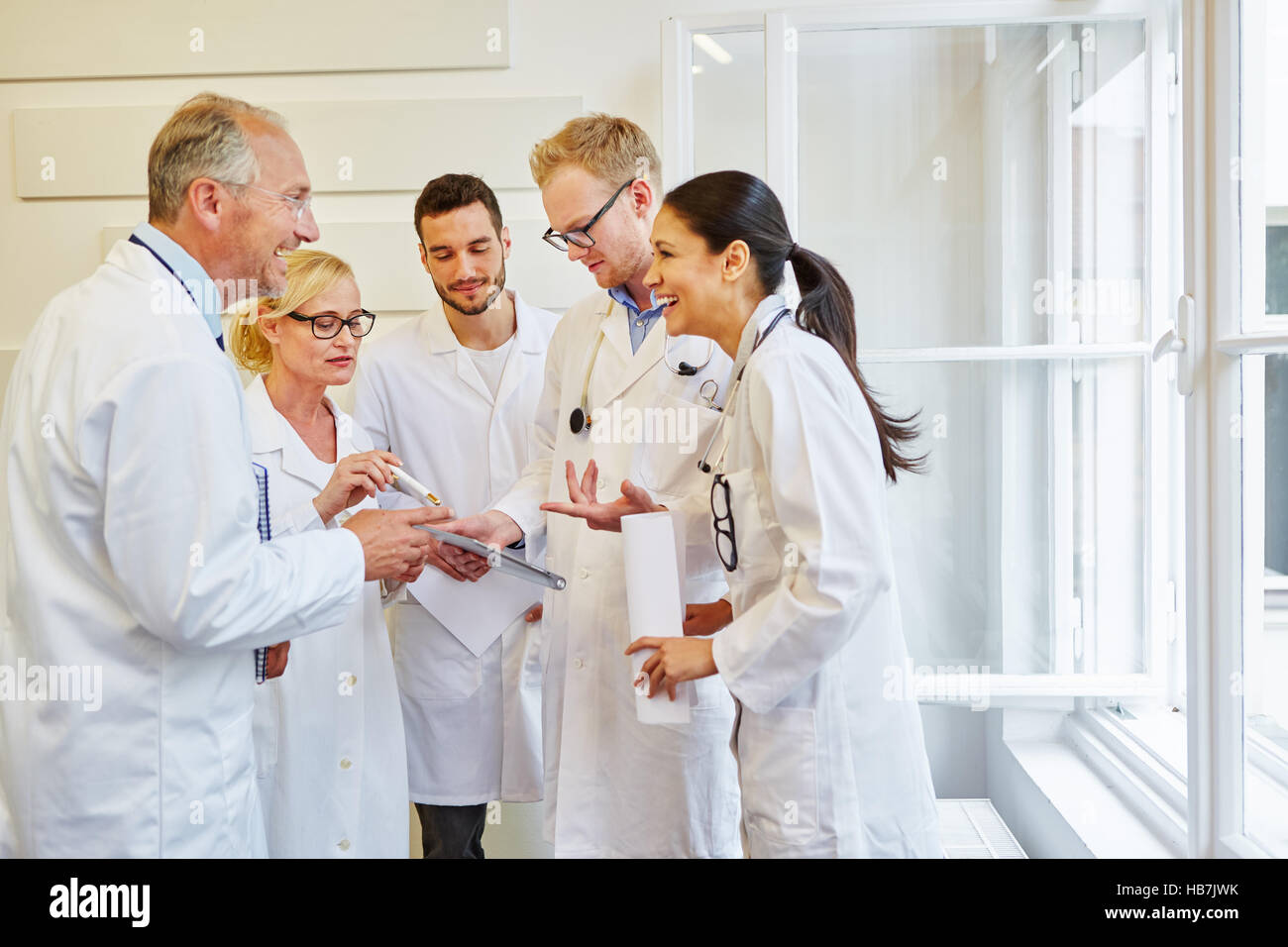 Team of successful doctors laughing with joy in meeting Stock Photo - Alamy
