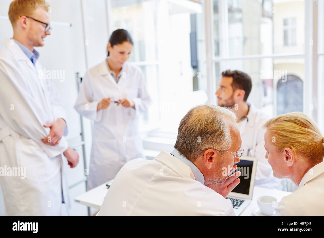 Chief doctor and team in meeting in hospital Stock Photo - Alamy