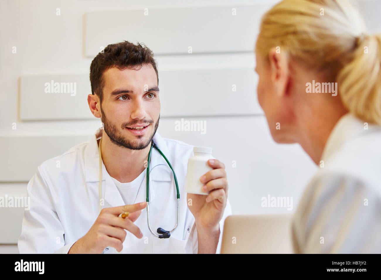 Doctor explains tablet consumption for therapy Stock Photo - Alamy