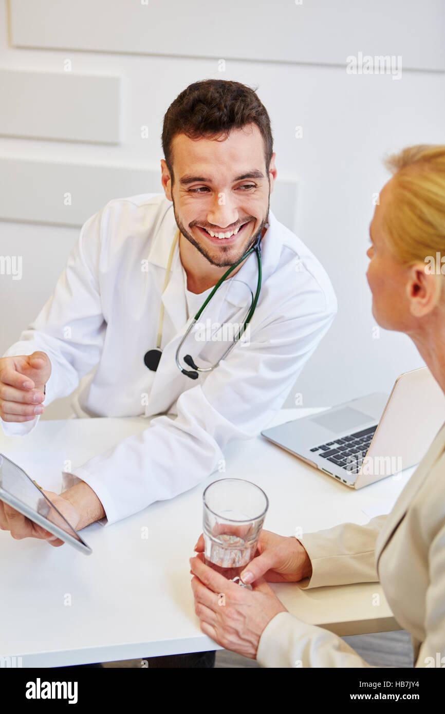 Doctor giving friendly advice to patient in consultation Stock Photo ...