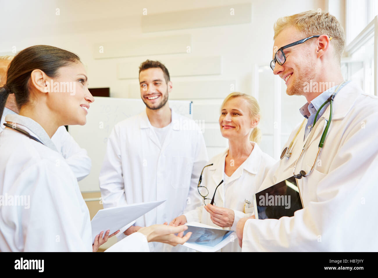 Team of doctors in meeting cooperating and working together Stock Photo ...