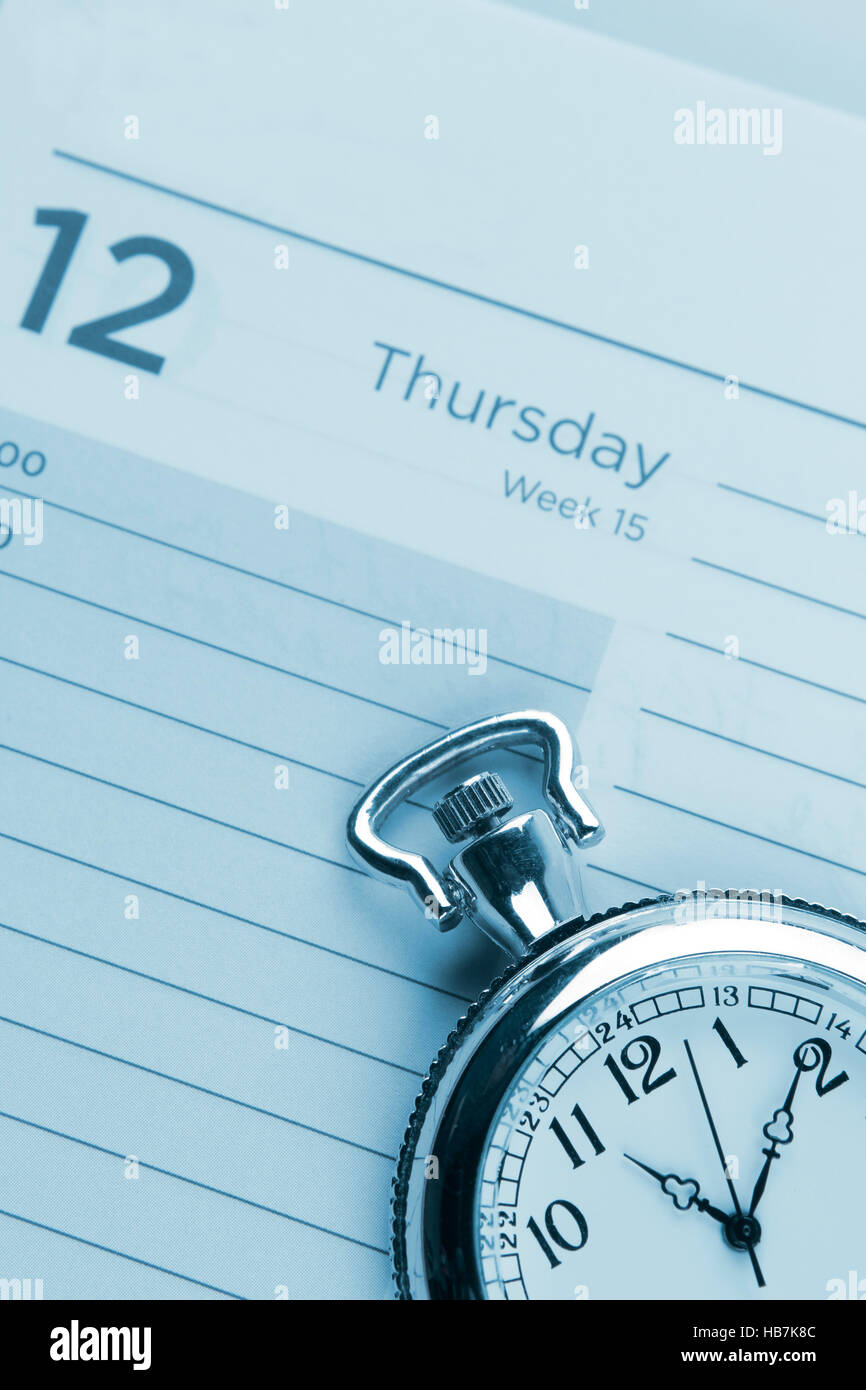 Pocket watch on diary page Stock Photo - Alamy