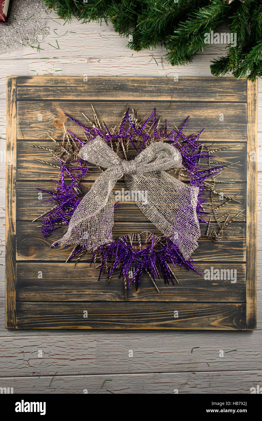 Decorative wreath designed with violet and golden decorations and ...