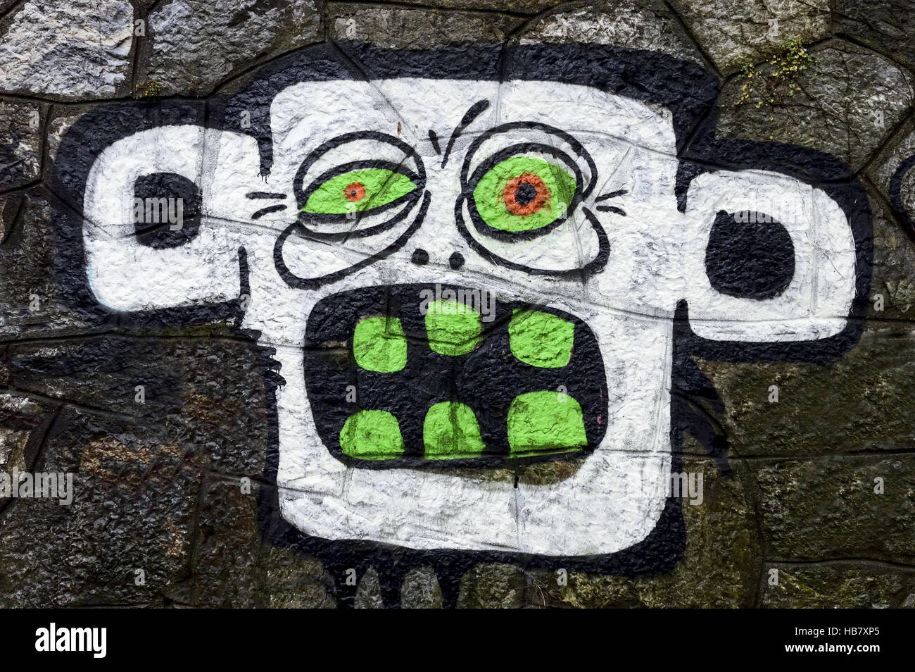 Grimace of a monster on the wall Stock Photo - Alamy