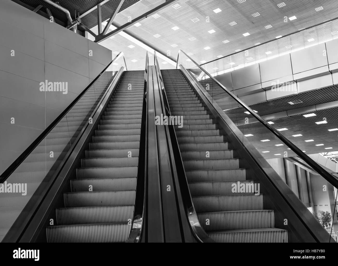 Escalator room with glass Stock Photo - Alamy