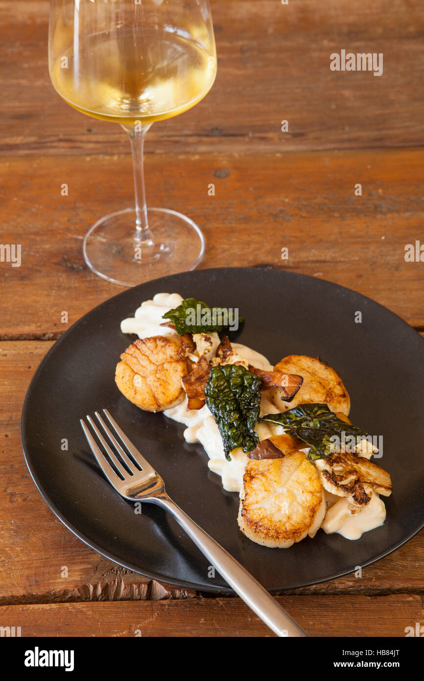 seared scallops with ricotta cavatelli and a glass of chardonnay wine ...