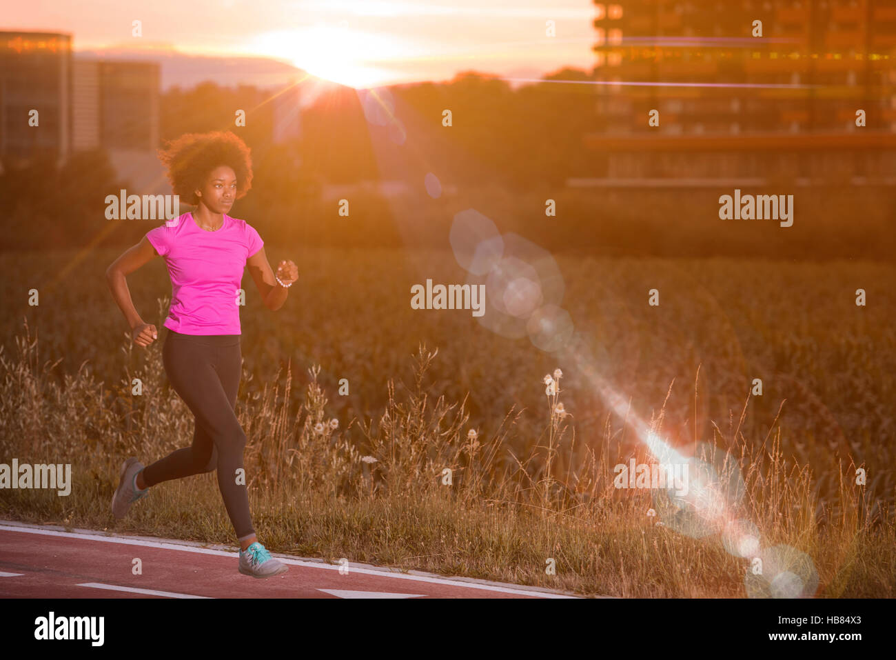 young beautiful African American woman enjoys running outside beautiful ...