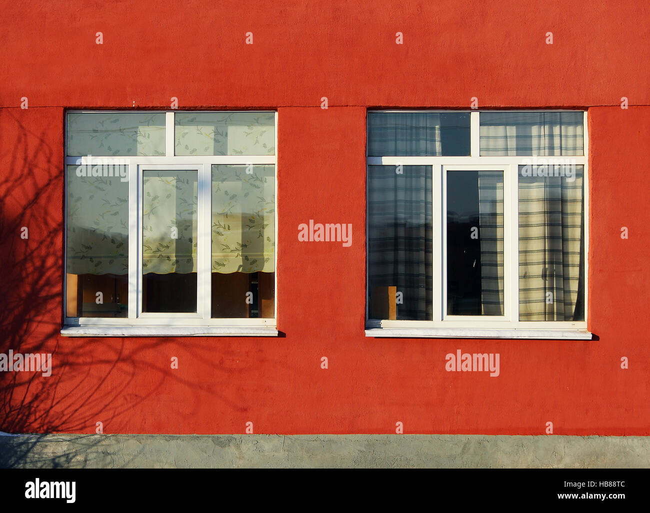 texture of a bright brick-colored plaster and windows at the clinic ...