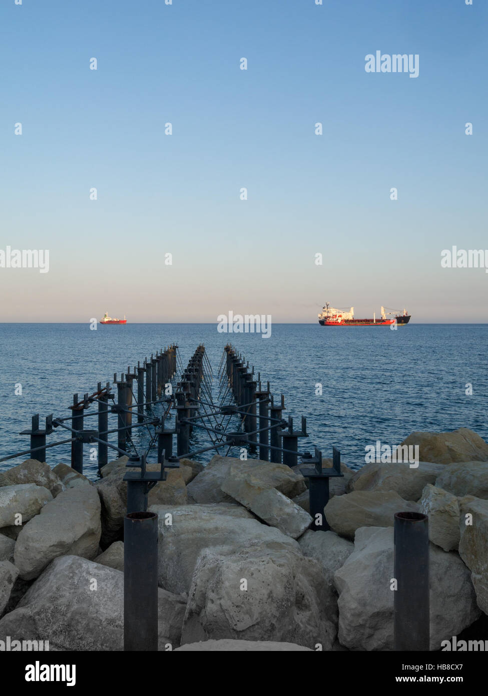Jetty into the sea at Limassol, Cyprus with a ship on the horizon Stock ...
