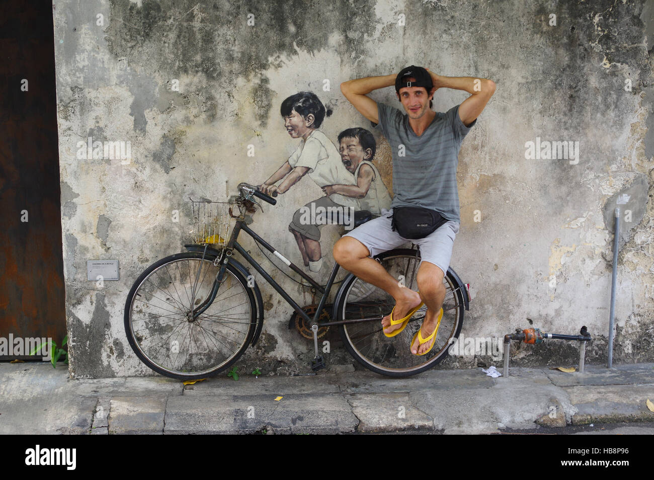 PENANG, MALAYSIA - APRIL 18, 2016: Local tourist poses in-front of Street Mural tittle 'Little ...