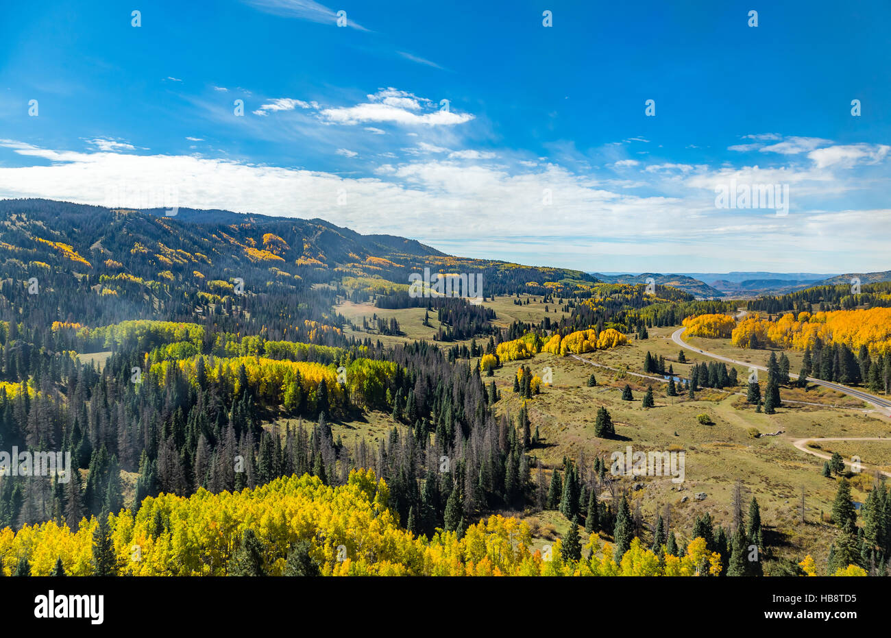 Mountain scenery with streams, valleys, and colorful trees along a ...