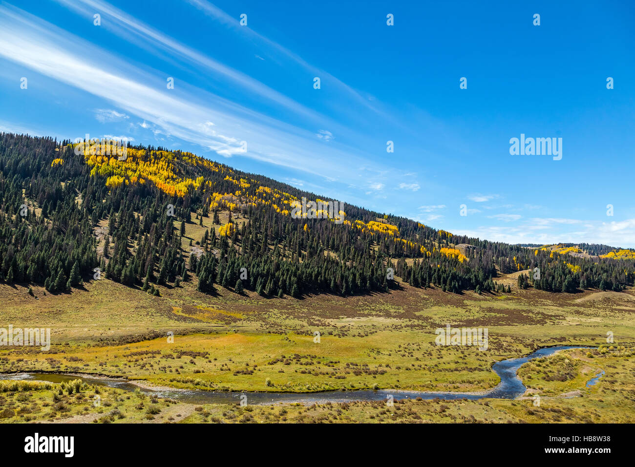 Mountain scenery with streams, valleys, and colorful trees along a ...