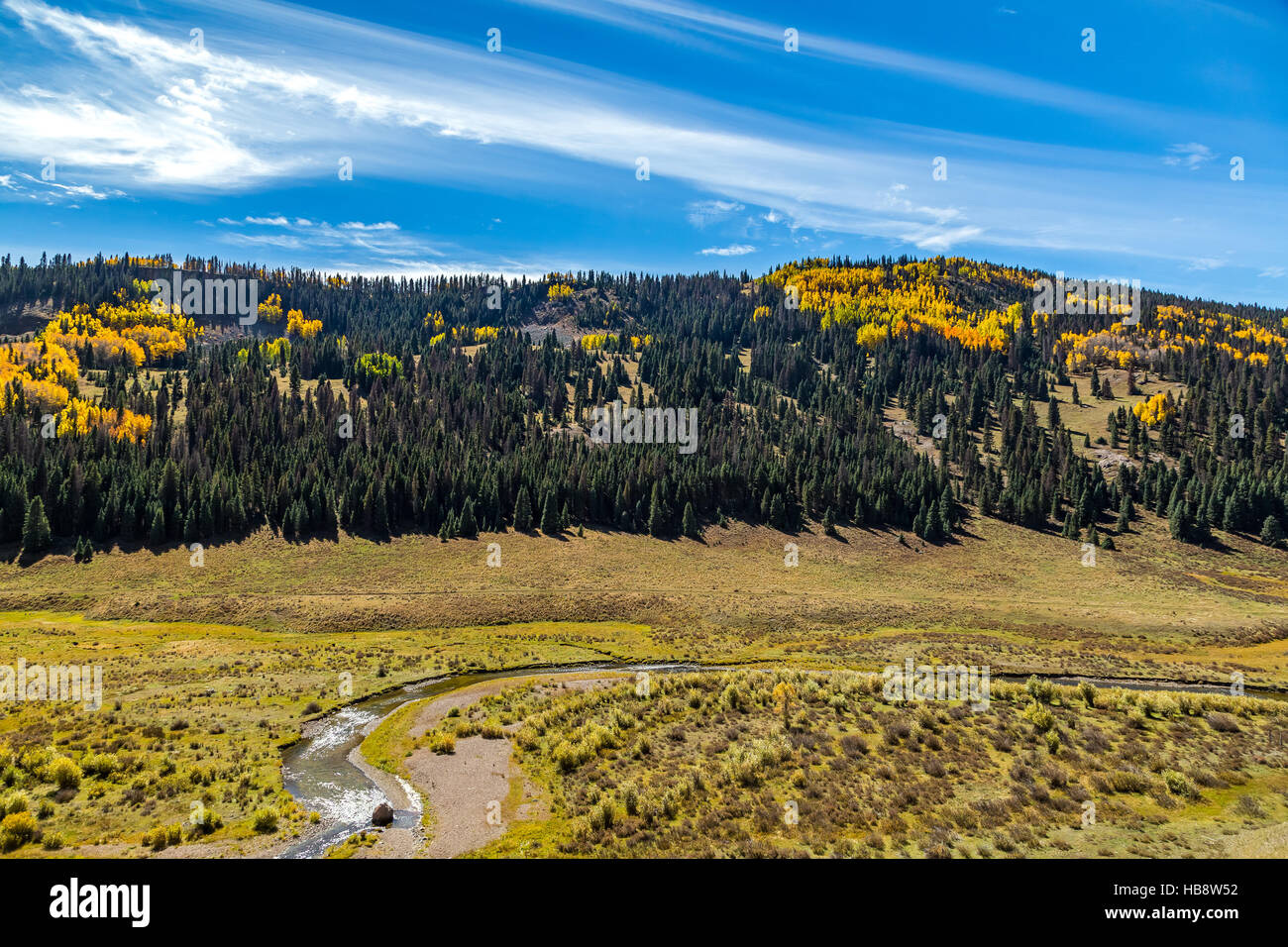 Mountain scenery with streams, valleys, and colorful trees along a ...
