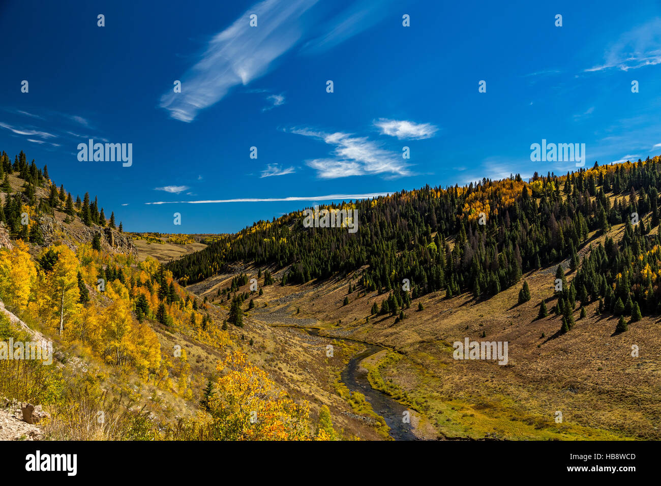 Mountain scenery with streams, valleys, and colorful trees along a ...