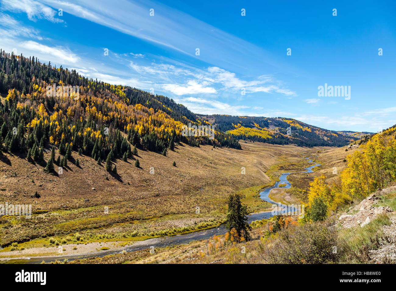 Mountain scenery with streams, valleys, and colorful trees along a ...