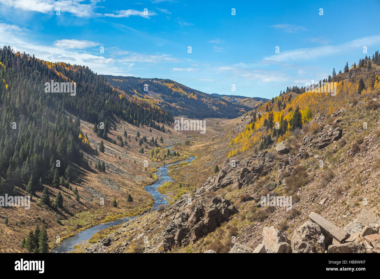 Mountain scenery with streams, valleys, and colorful trees along a ...