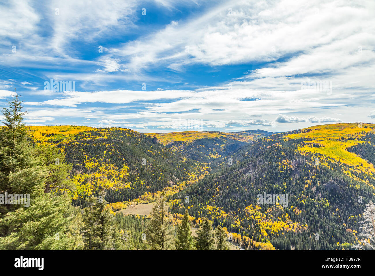 Mountain scenery with streams, valleys, and colorful trees along a ...
