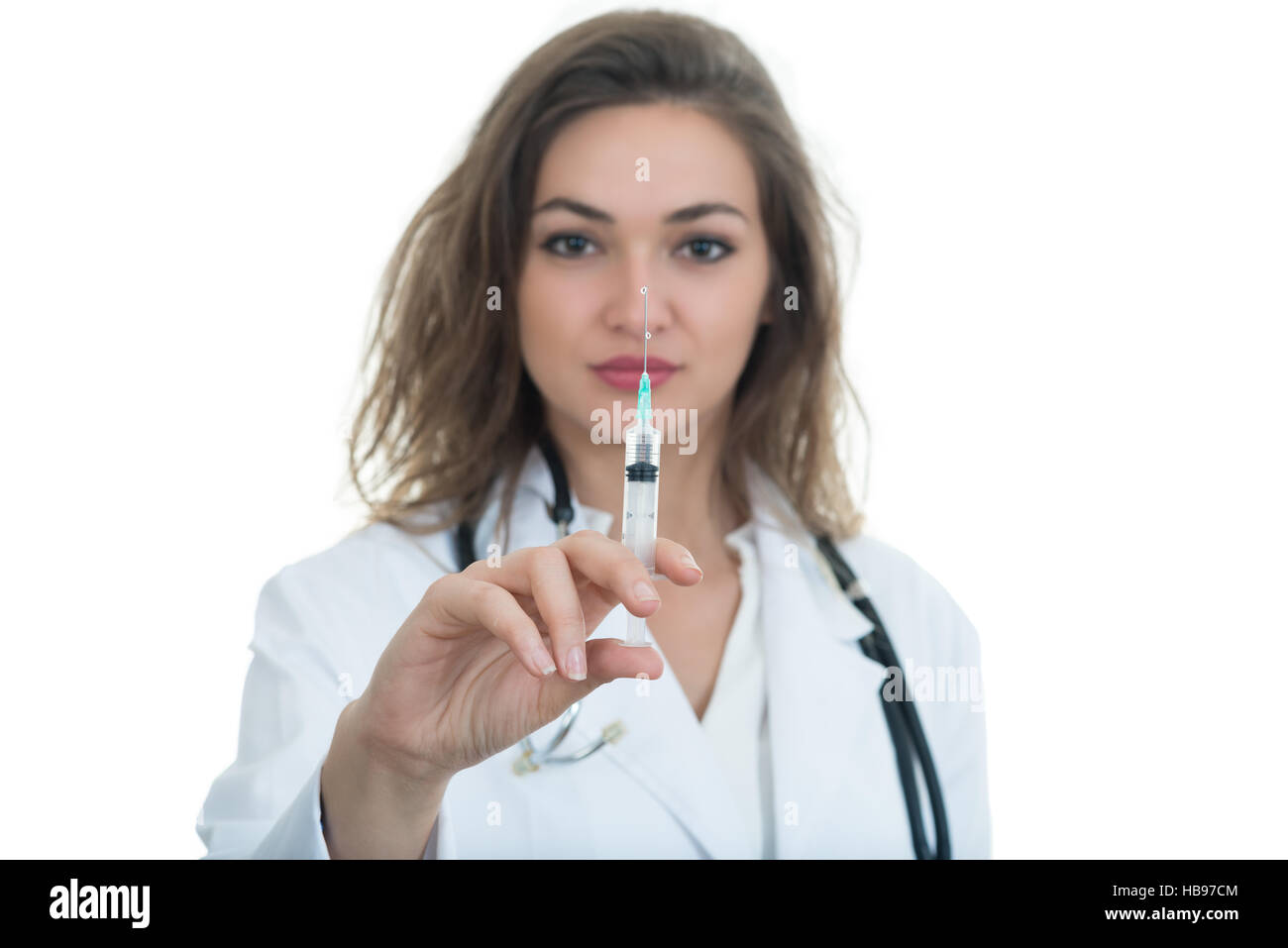 Female doctor checking a syringe isolated on white background Stock ...