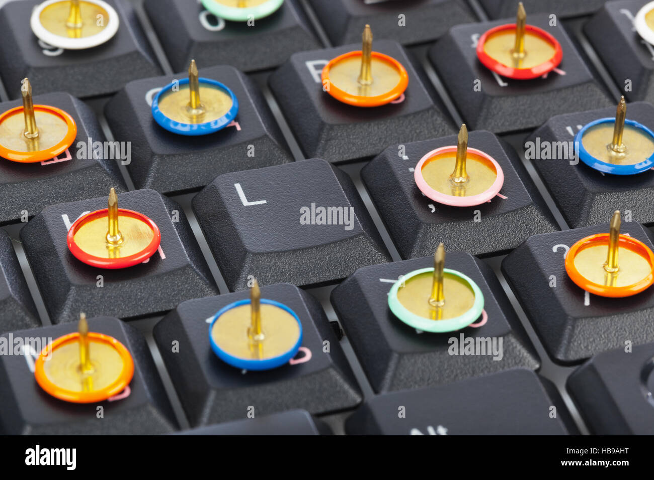 Pins on computer keyboard Stock Photo - Alamy