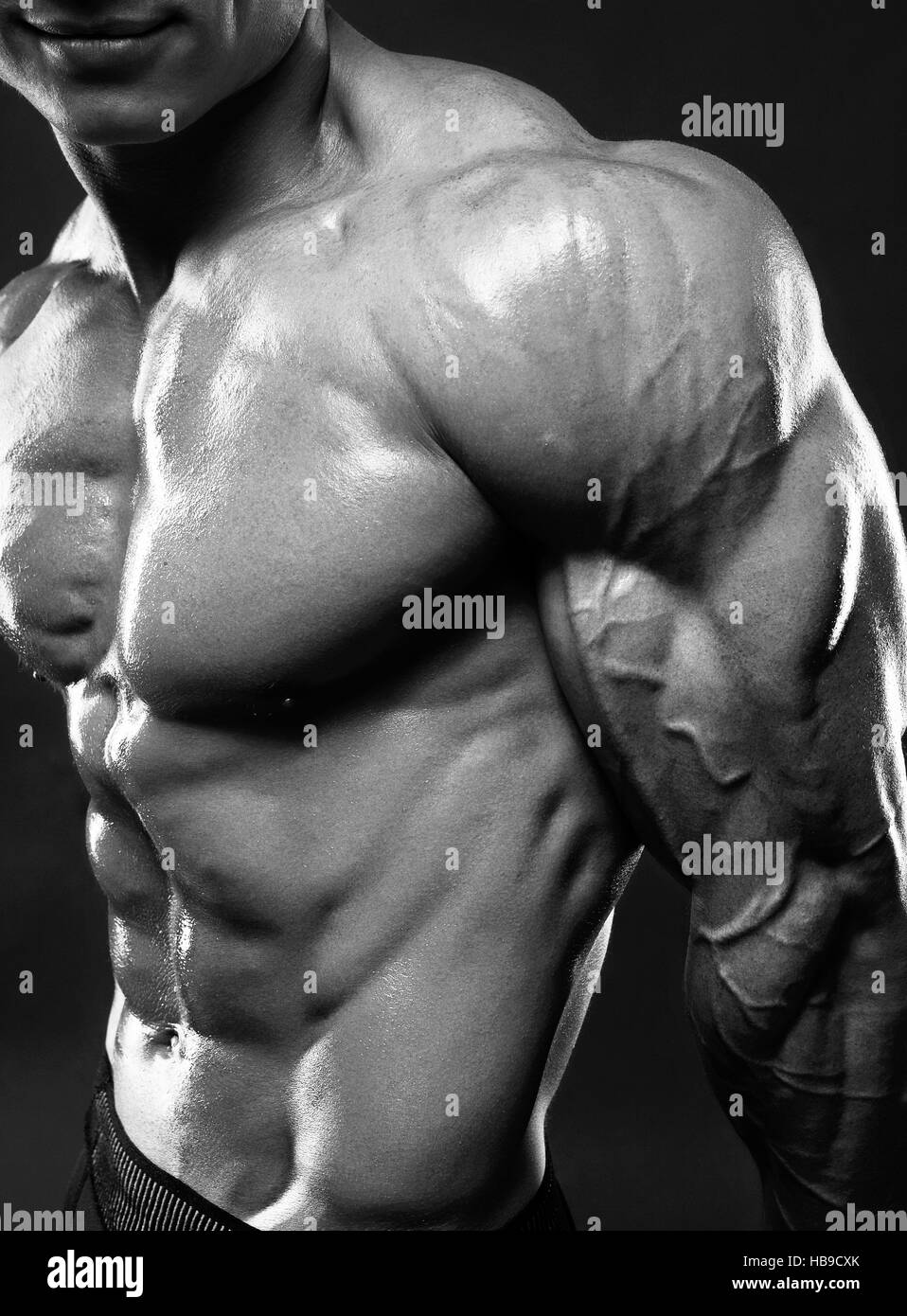 Muscled male model showing his biceps Stock Photo - Alamy