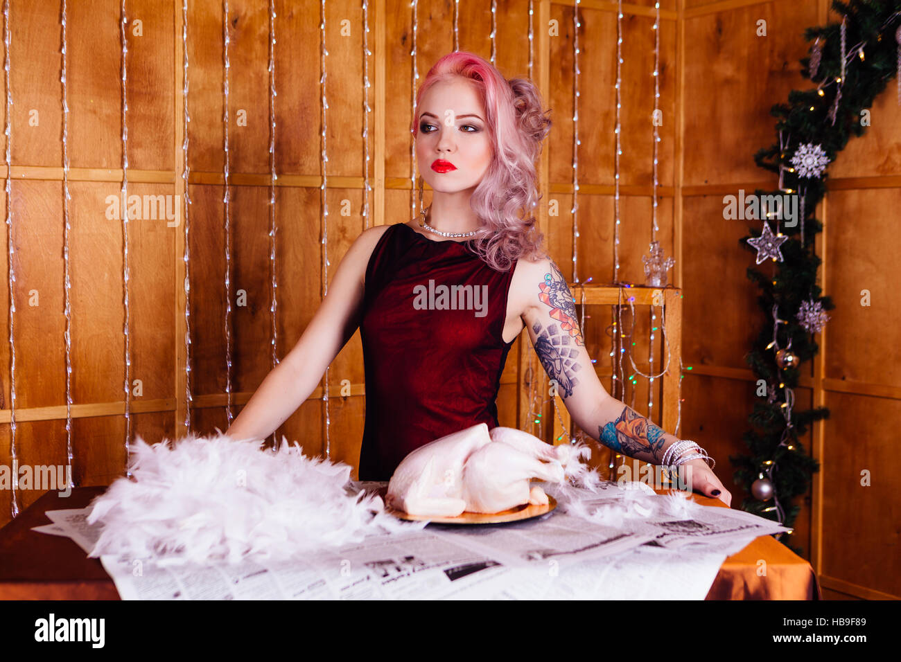 Gorgeous young woman in dress cooks crude hen Stock Photo - Alamy
