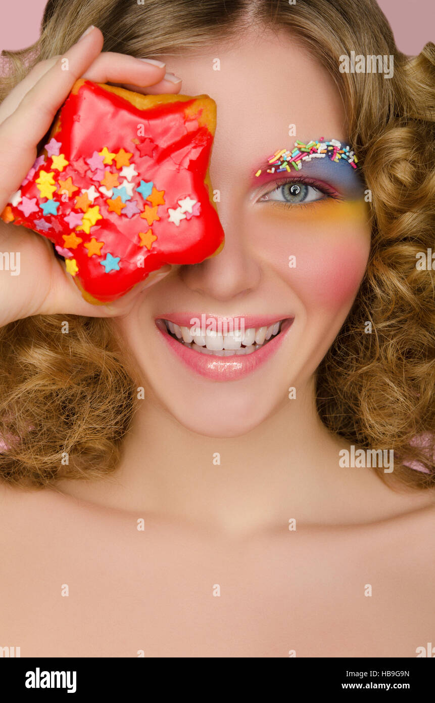 Young woman with donut in face Stock Photo - Alamy