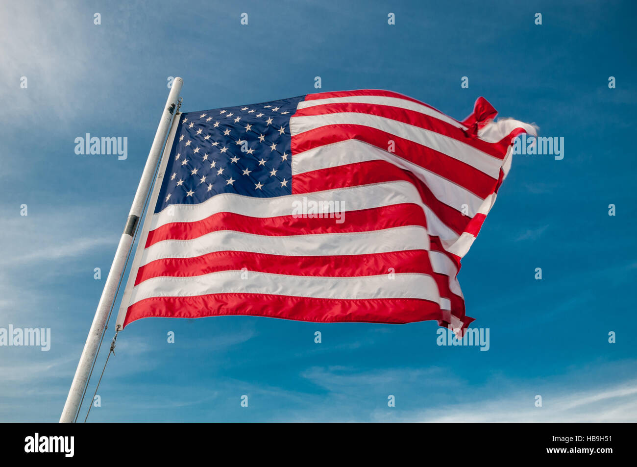 American flag against bright blue sky Stock Photo - Alamy