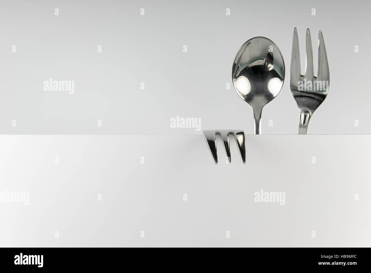 Figure of spoon and two forks Stock Photo - Alamy