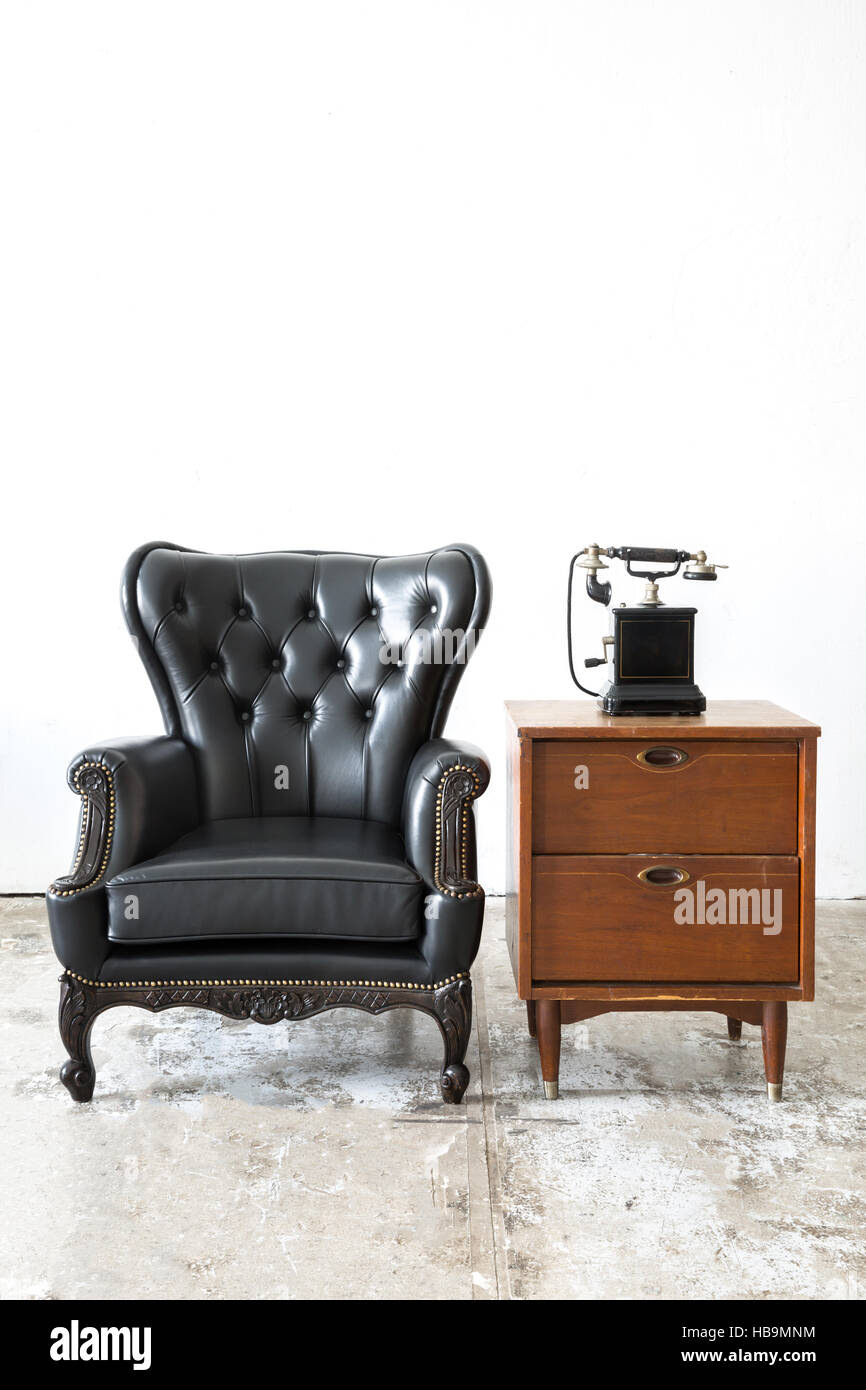 Retro leather chair with telephone Stock Photo - Alamy