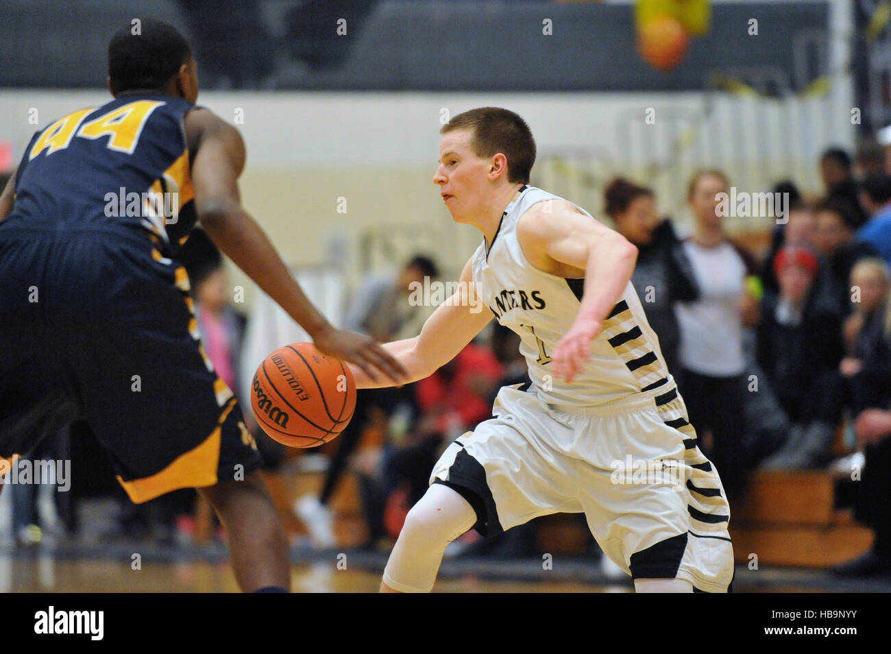 While a driving toward the hoop, a high school player puts a fake on a ...