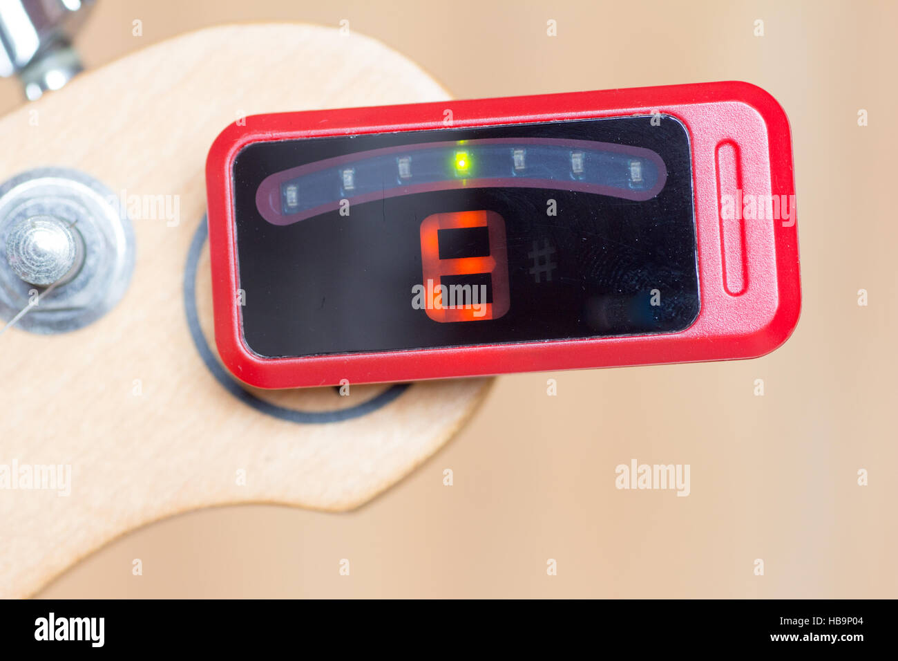 Series of tuning a guitar, E, accurate tuning by a digital tuner Stock ...