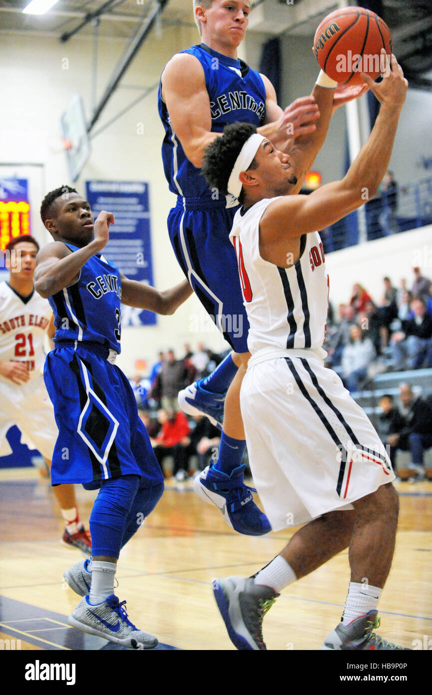 Player tracking down an elusive rebound in front of an opponent during ...