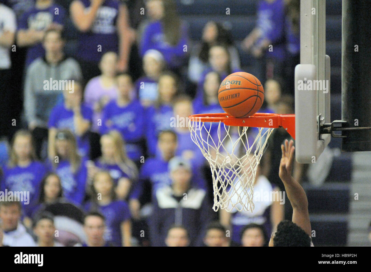 Ball teetering on the rim leaving players and fans to wait to see if ...