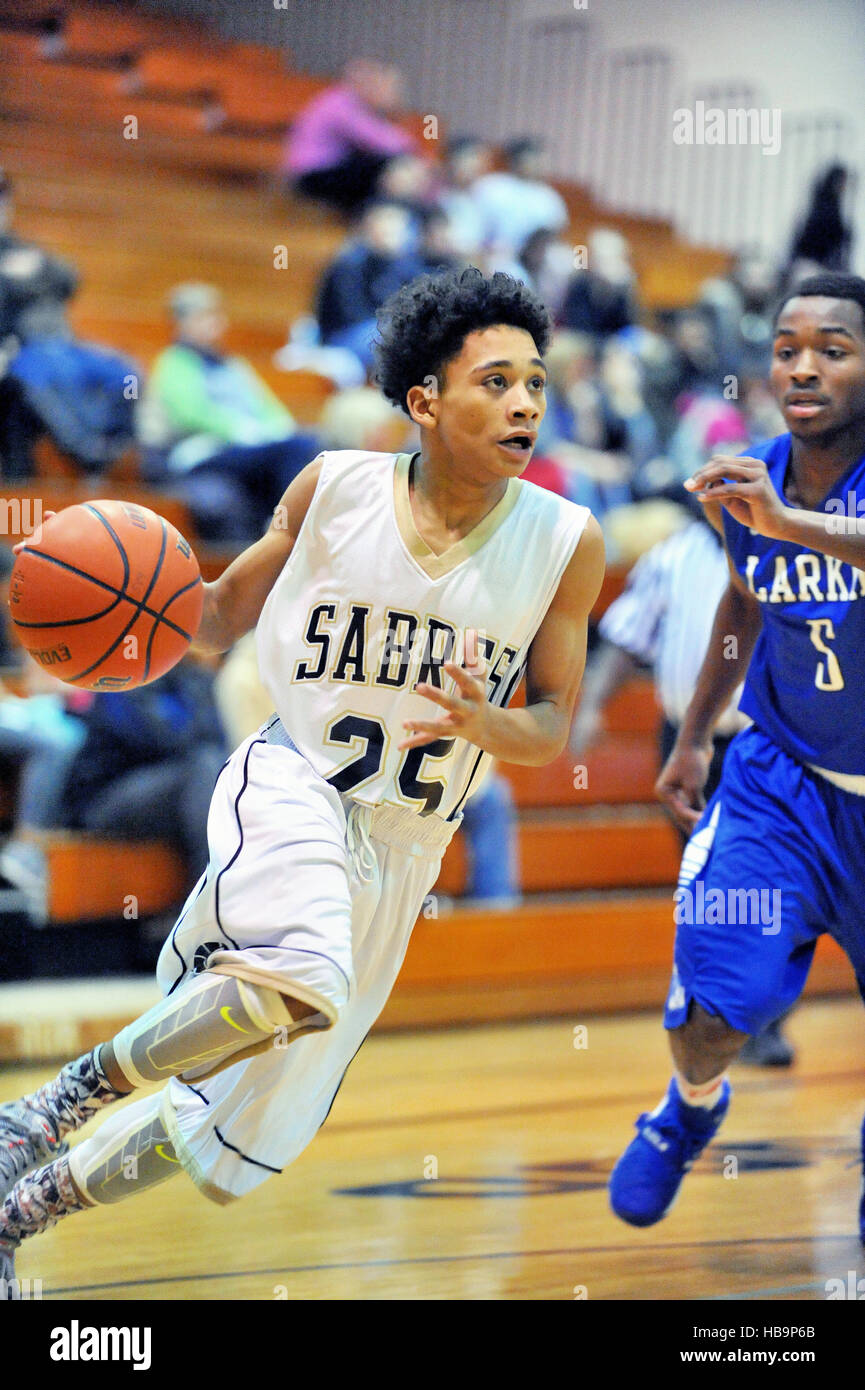 Player driving the baseline toward the opposing basket during a high ...