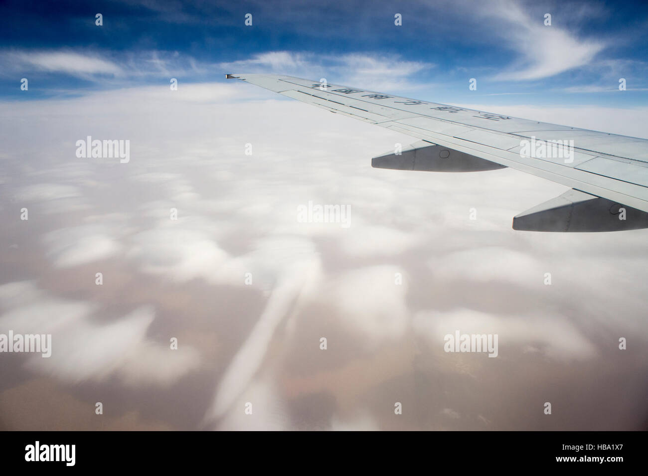 View of jet aircraft wing above the clouds Stock Photo - Alamy
