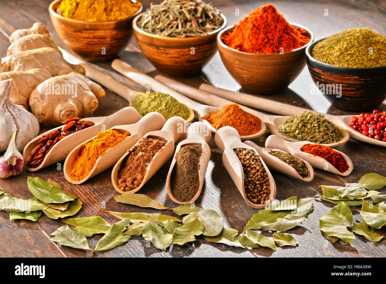 Variety of spices on kitchen table Stock Photo - Alamy