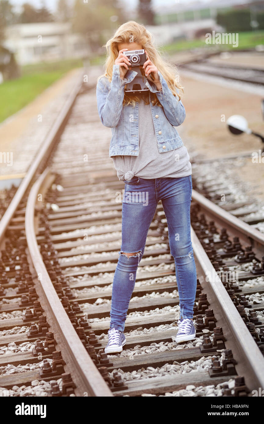 Young female taking pictures Stock Photo - Alamy