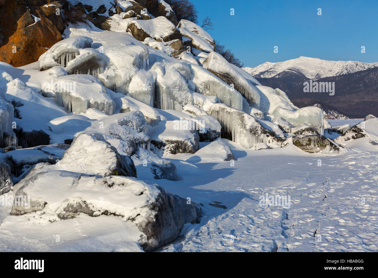 Huge icicles on rocks Stock Photo - Alamy