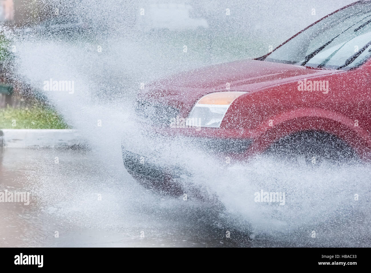 car rain puddle splashing water Stock Photo - Alamy