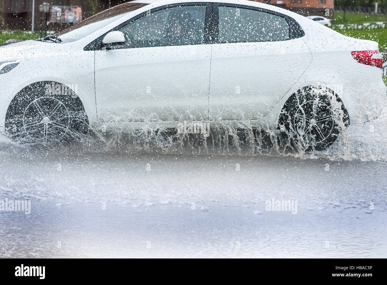 car rain puddle splashing water Stock Photo - Alamy