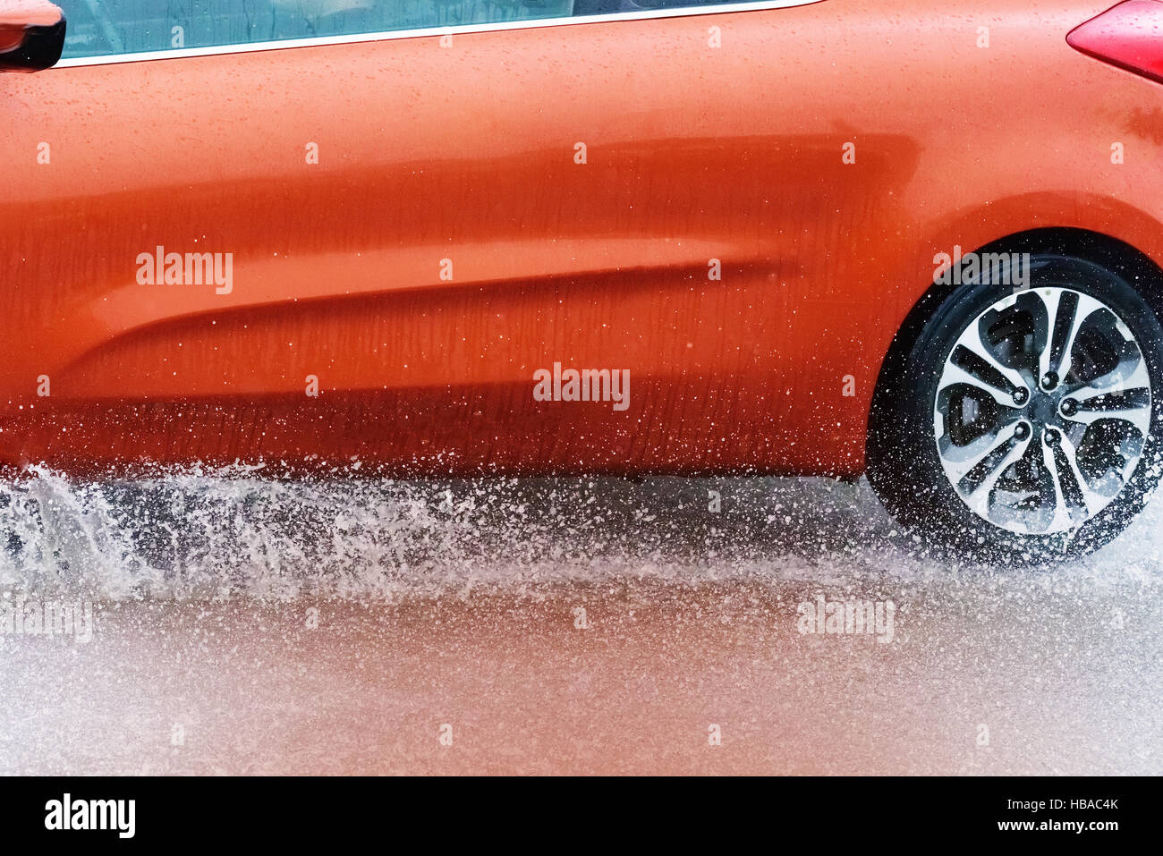 car rain puddle splashing water Stock Photo - Alamy