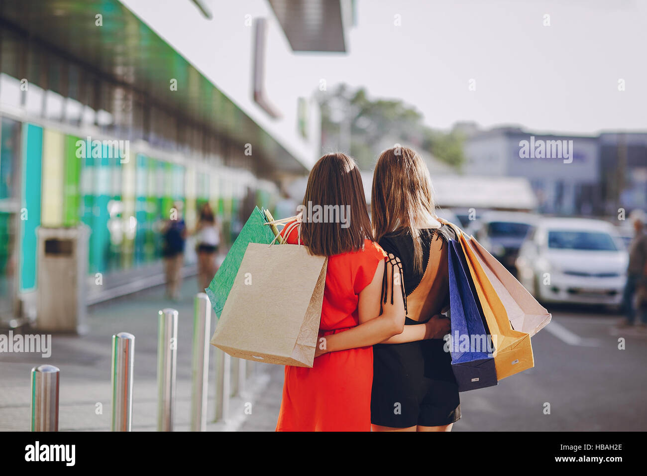 two beautiful young women walk to the shops and make purchases Stock ...