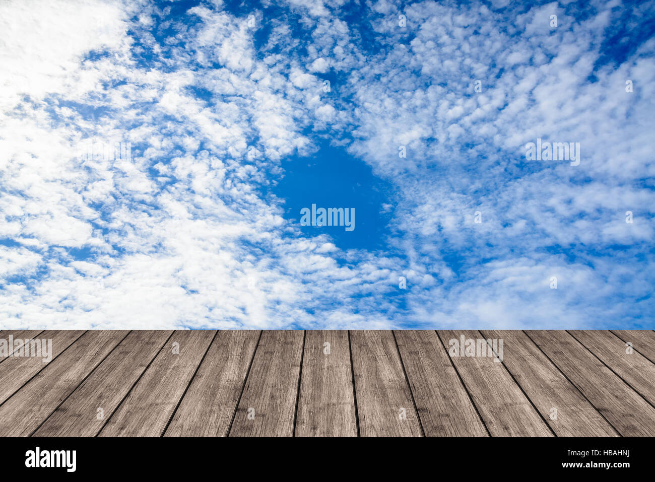 Wooden table or terrace on Deep blue sky and clouds. Space for your ...