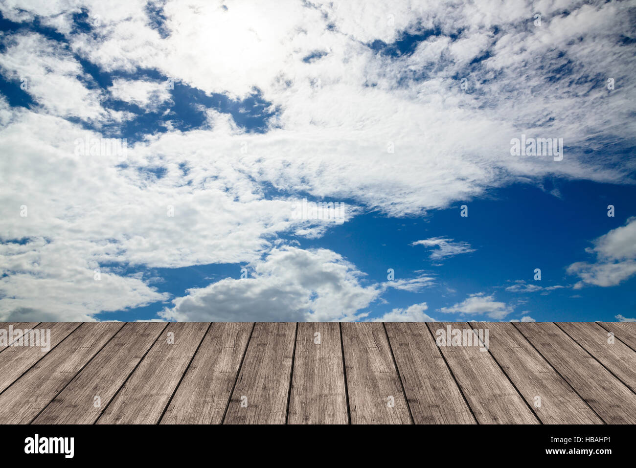 Wooden table or terrace on Deep blue sky and clouds. Space for your ...
