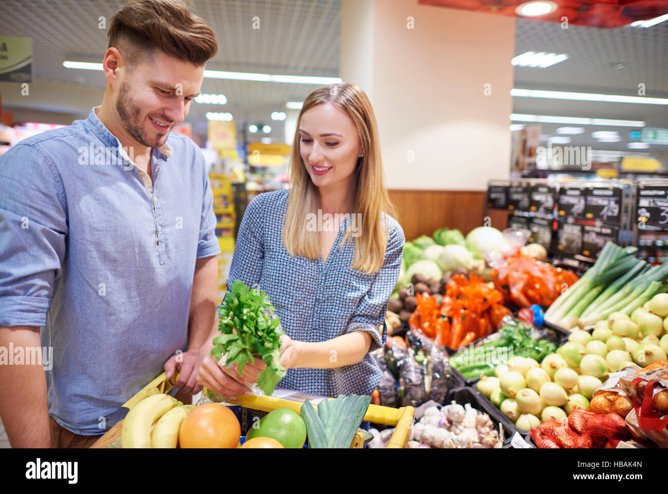 Couple choosing fresh food in supermarket Stock Photo - Alamy