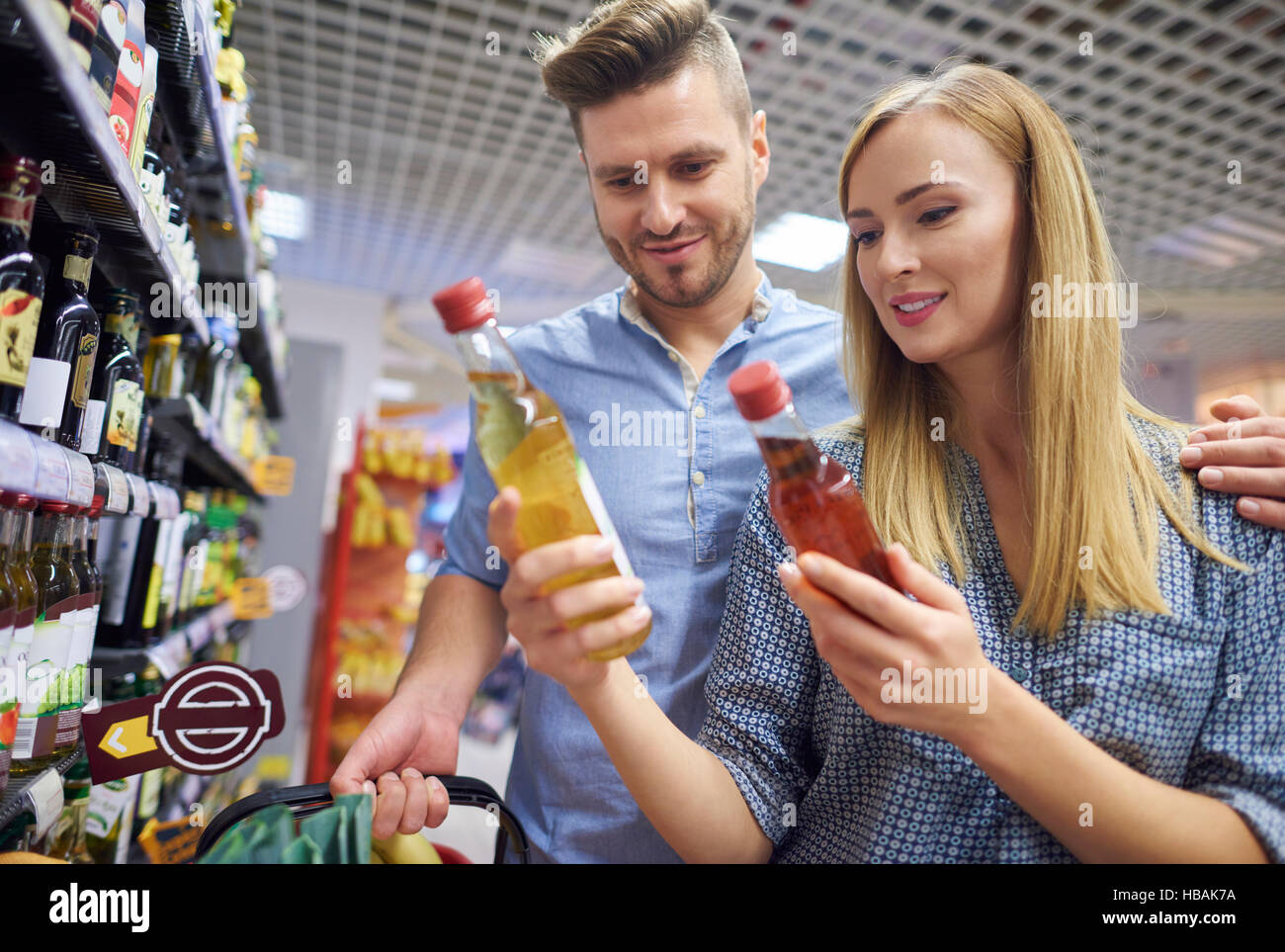Woman choosing better and cheaper product Stock Photo - Alamy