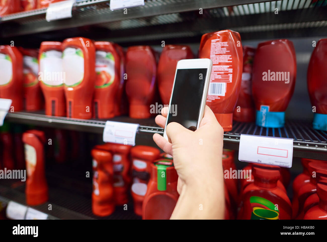 Using mobile phone while shopping Stock Photo - Alamy