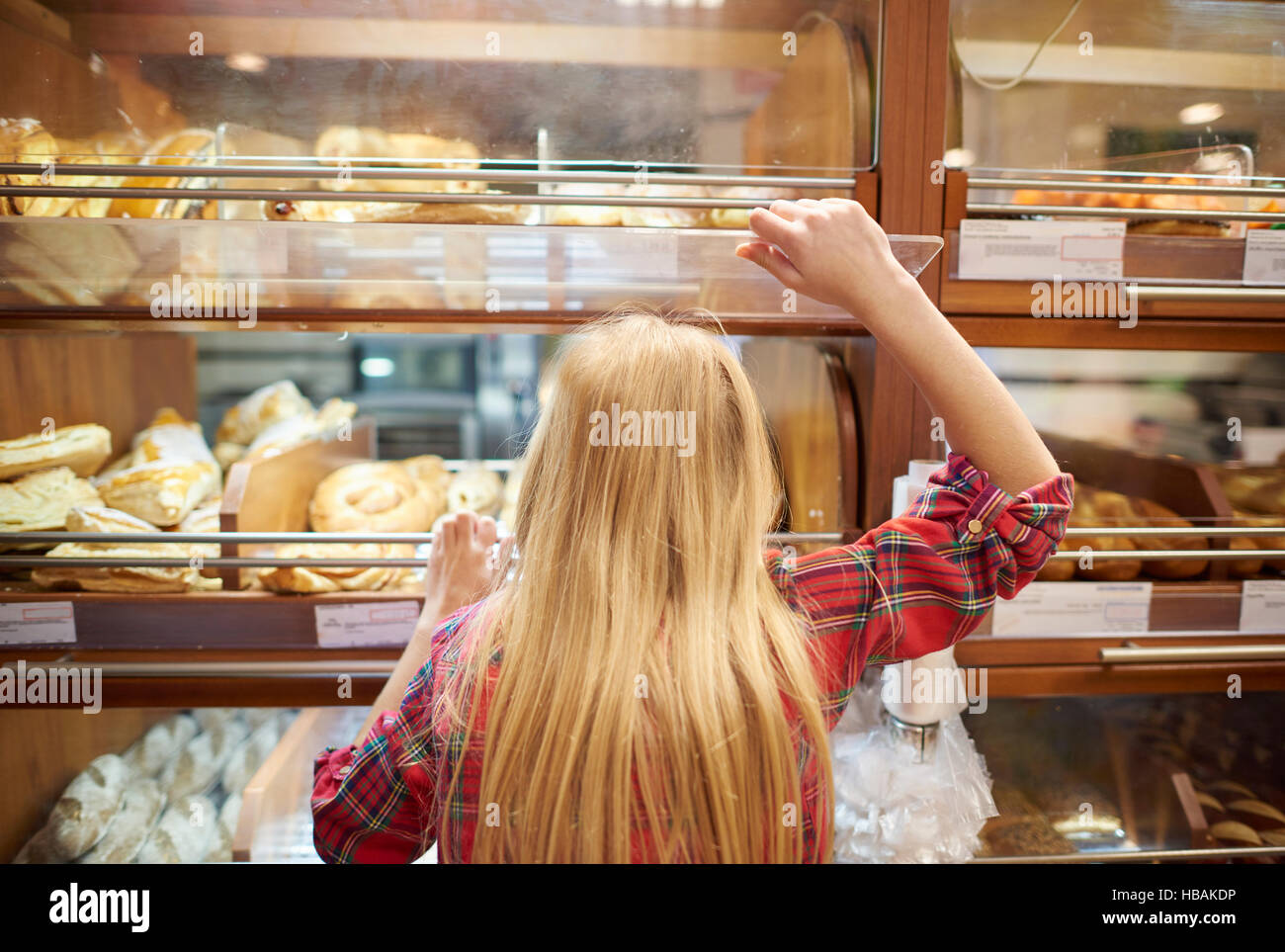 Little girl grabbing some fresh bread and roll Stock Photo - Alamy