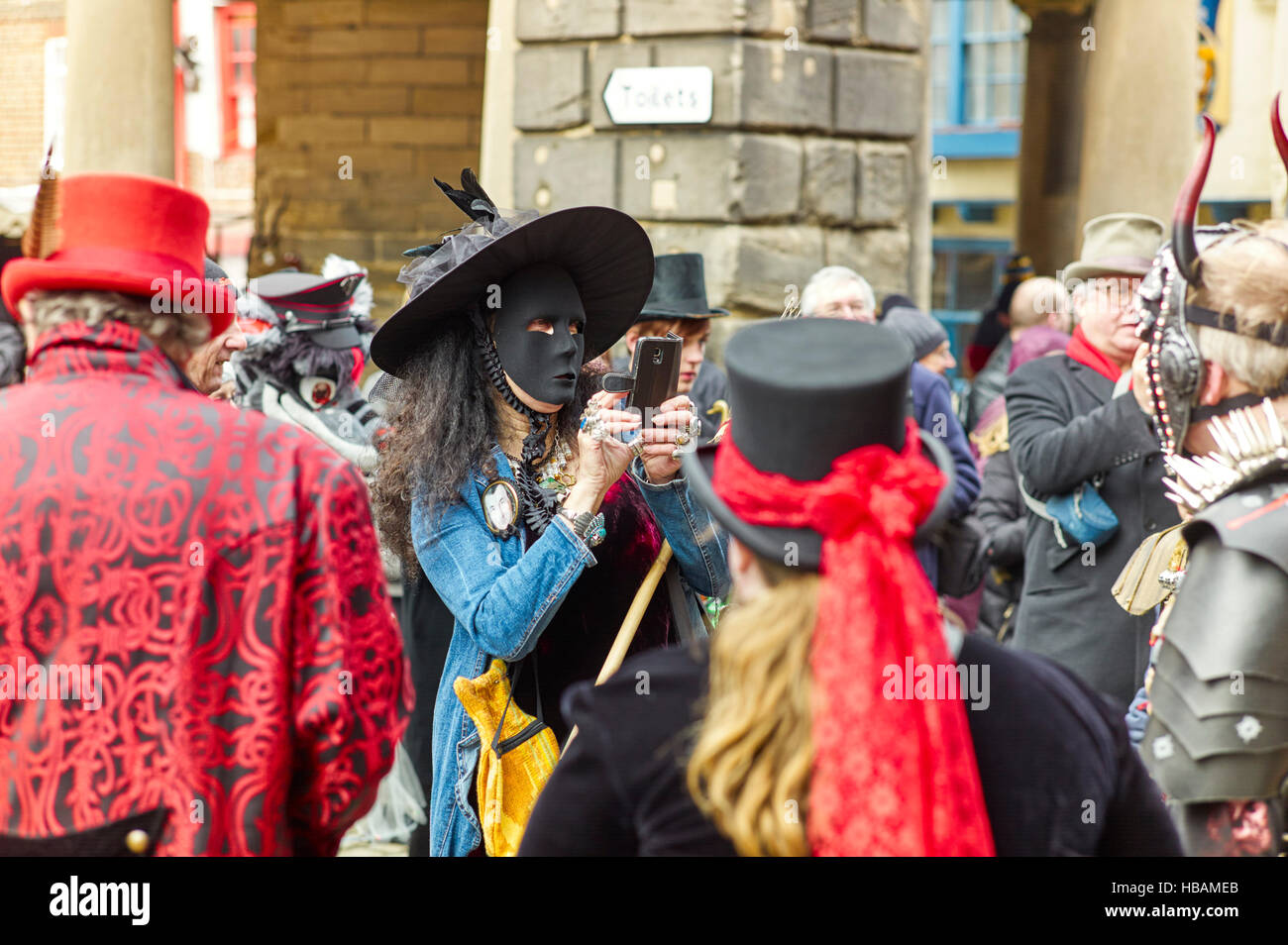 Woman taking phone pic during goth weekend at Whitby Stock Photo - Alamy